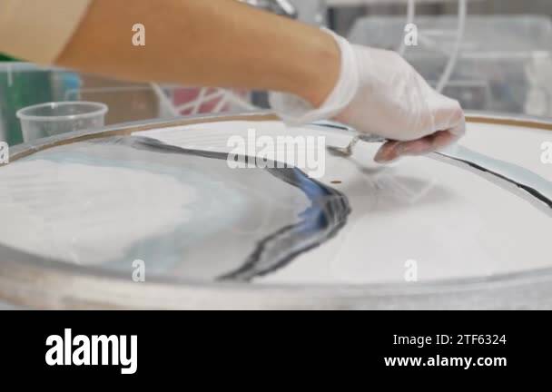 Epoxy design - smearing white epoxy resin on round painting using a ...