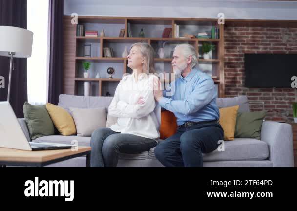 quarreled senior couple husband calms and supports wife. Sad depressed ...