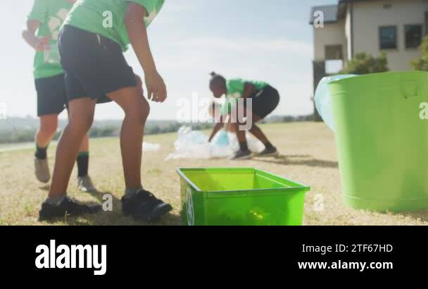 Video of diverse boys picking up trashes in front of school. primary ...