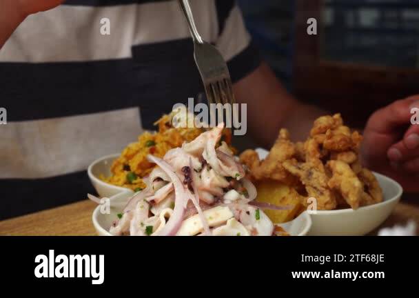 close-up eating a marine trio of fish chicharron, seafood chaufa and ...