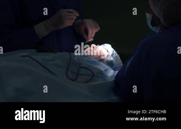 Plastic surgeon checking pen marking dissection on eyelid of young ...