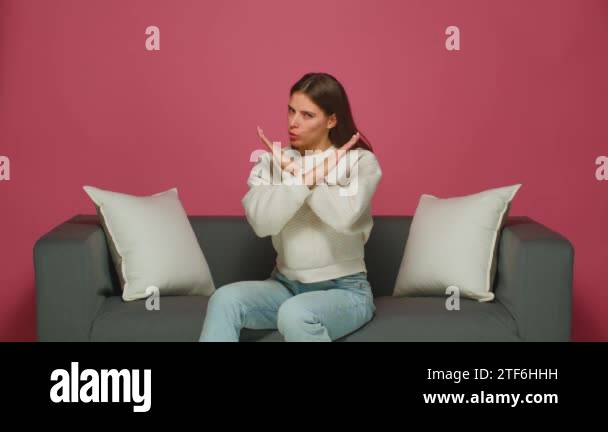 Serious young girl show stop hand gesture, says no, refuse of something ...