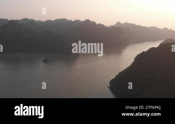 Aerial: unique flying over Ha Long Bay and Cat Ba island at sunset ...