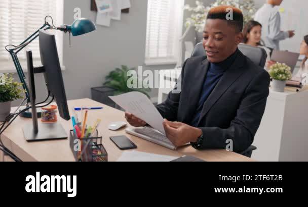 Boss working in an office man is sitting behind desk in front of ...