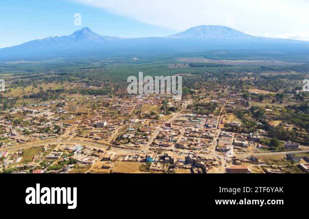 Mount kilimanjaro view . Small settlement of houses with Kilimanjaro ...