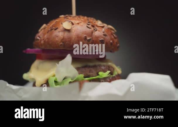 Handmade burger rotates on crumpled paper Stock Video Footage - Alamy