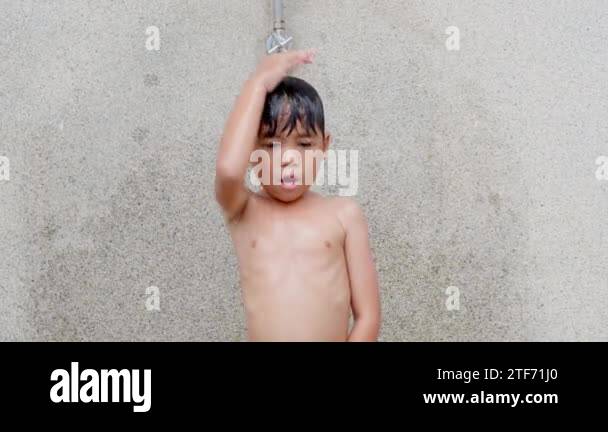 Asian child little boy taking shower at the swimming pool resort, Happy ...