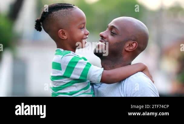 Father and son doing eskimo kiss. African black dad and child bonding ...