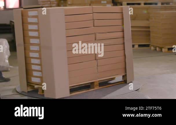 Packaging boxes with products in plastic film at the factory. A special ...