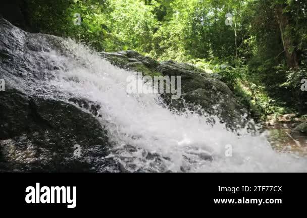 Slow motion of river or lake waterfall in tropical river beautiful ...