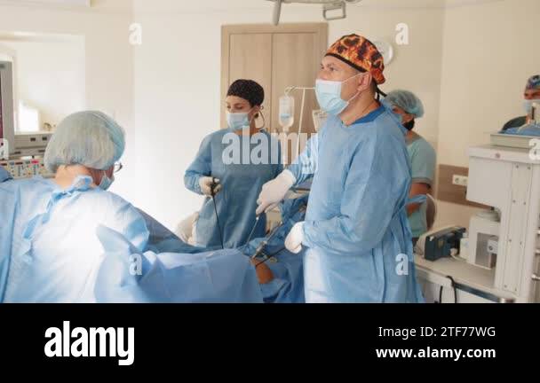 Surgeons team performing operation in hospital operating theater ...