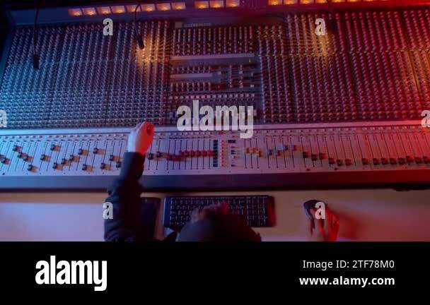 Cinematic top view of professional male sound producer is recording a ...