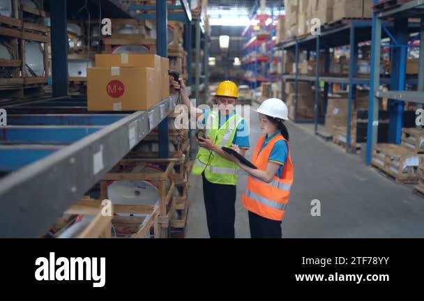 Young Asian woman worker using barcode scanner checking goods and box ...