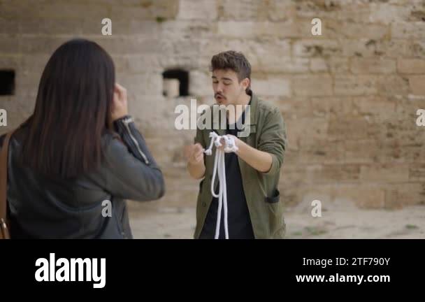 Consummate mastery of magician. The magician shows a trick with a rope ...