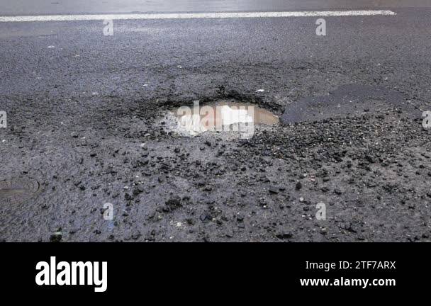 Pothole on street Stock Videos & Footage - HD and 4K Video Clips - Alamy