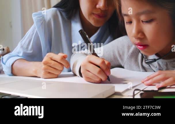4K Asian young little girl using laptop to study with her mother ...
