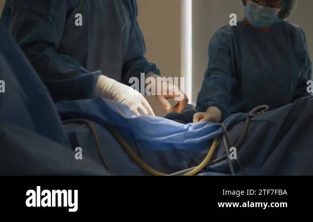 Surgeon ties knots for stitches on open wound. In the Hospital ...