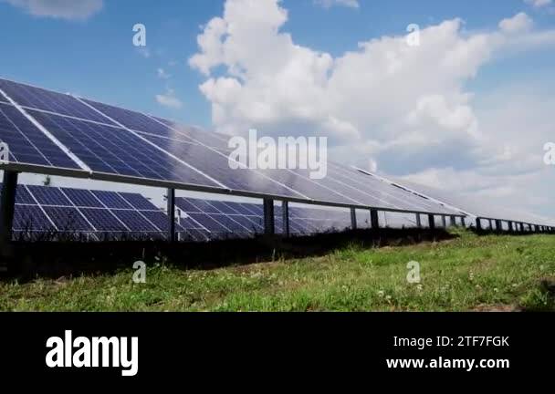 Walk along a row of photovoltaic solar panels. Solar power plant in the ...