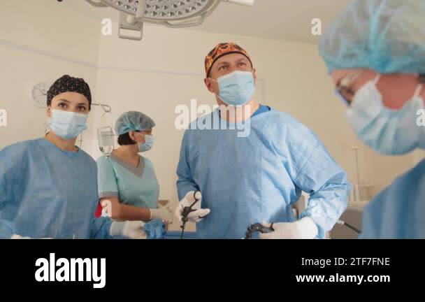 Team of Professional Surgeons Performing Invasive Surgery on a Patient ...
