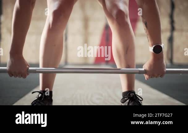 Strong spanish woman doing barbell lifting workout at the gym ...