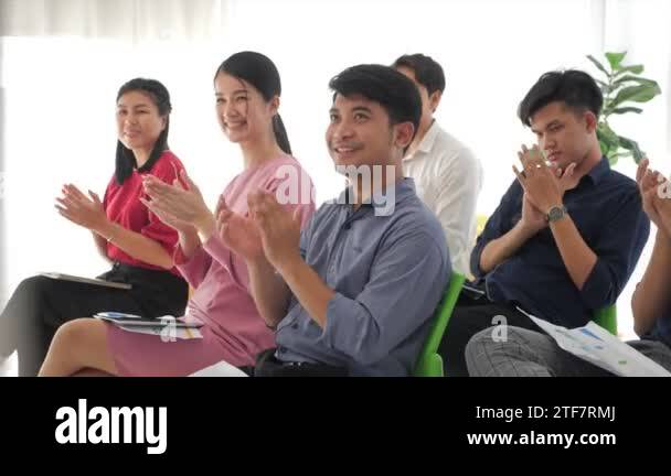 Group of Asian business people clapping their hands together in ...