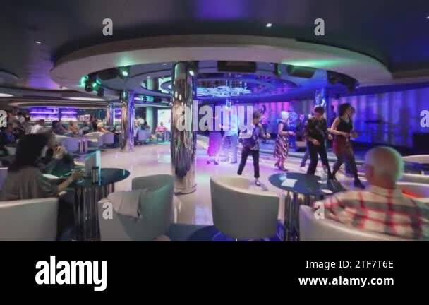 4k, passengers dancing in a night bar on the deck of a cruise ship MSC ...
