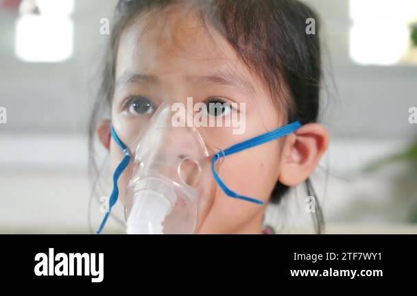 Kid girl making makes inhalation nebulizer steam sick cough at home ...