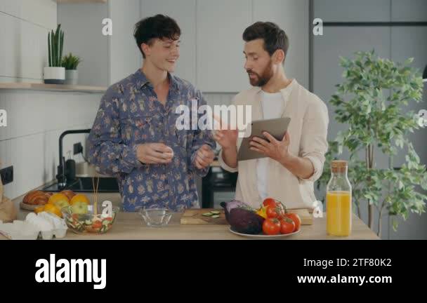 Lgbt couple in love standing together in their new apartment in the ...