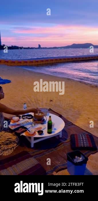 women bbq cooking noodle soup during sunset in Thailand Ban Amphur ...