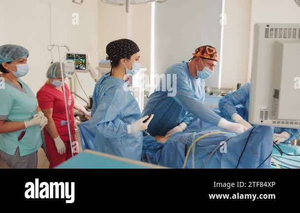 Cooperating of doctors and surgeons processing surgical operation in ...