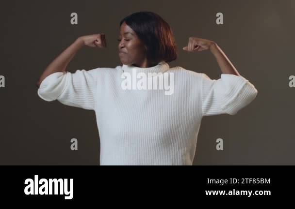 Cool proud african american woman showing biceps, make muscles gesture ...