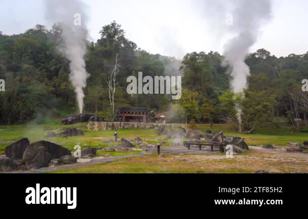 Fang Hot Springs and rocky terrain with the misty morning and natural ...