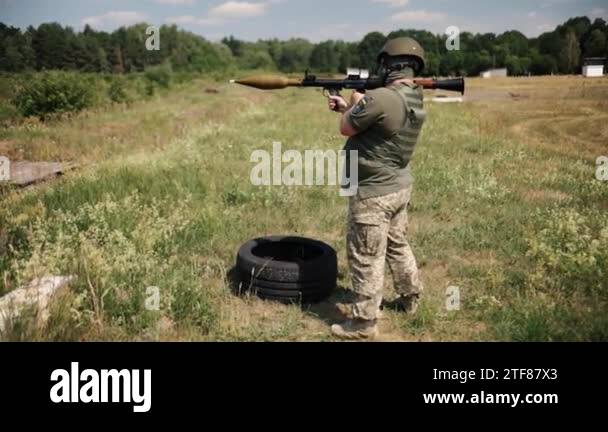 The soldier wears a helmet, military uniform, and body armor while ...