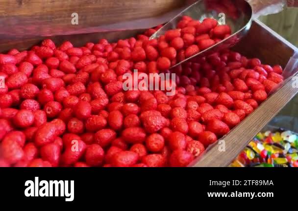 strawberry jelly sweets on the counter are laid out all the colors of ...