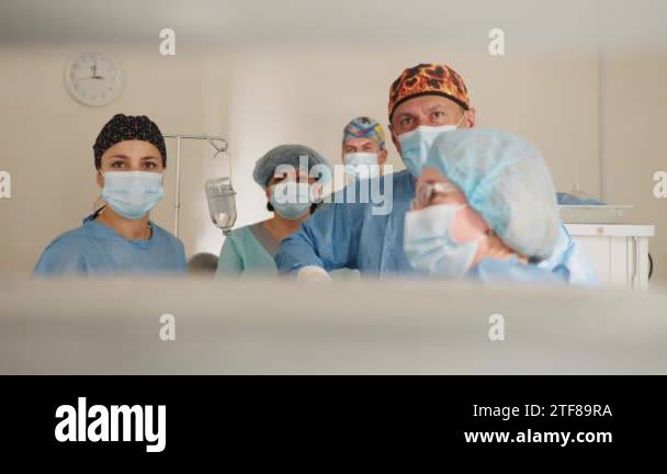 Team of surgeons performing operation in hospital. Surgeon male ...