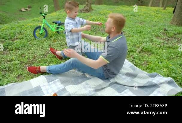 Beautiful family portrait of the pretty cheerful son running to father ...