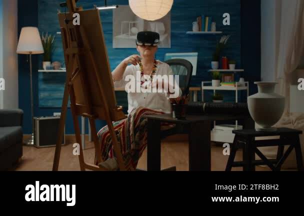 Senior artist using vr glasses with augmented reality to draw vase and ...