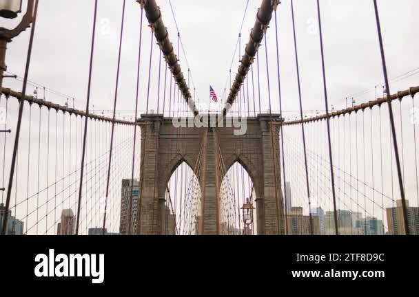 Bottom Up View of Brooklyn Bridge Towers with American National Flag on ...