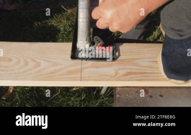 Cutting wood planks with a circular. A carpenter works with wooden ...