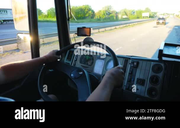 Unrecognizable lorry driver holding hands on steering wheel and ...