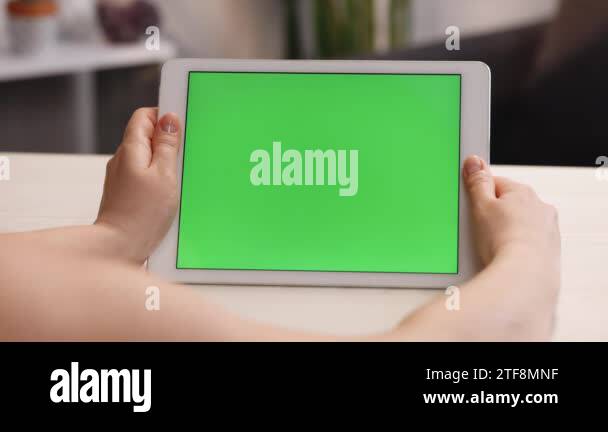 Close up Horizontal hands holding tablet computer with green screen for ...