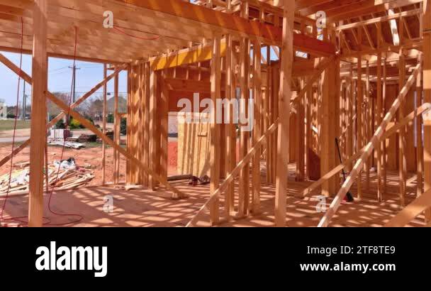 Wood frame house under construction in suburban new stick beams built ...