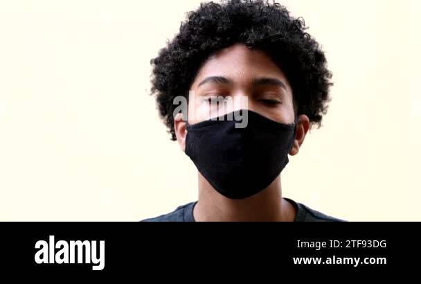 Boy removing covid-19 face mask feeling relief Stock Video Footage - Alamy