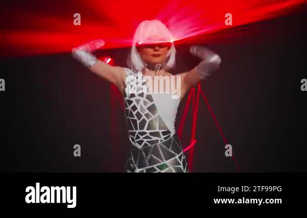 Medium shot portrait of woman in cyber costume with red laser beam ...
