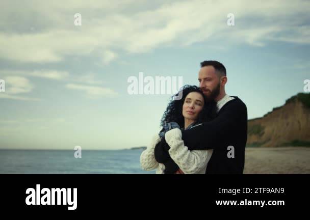 Romantic people hugging at seaside beach. Calm couple showing love on ...