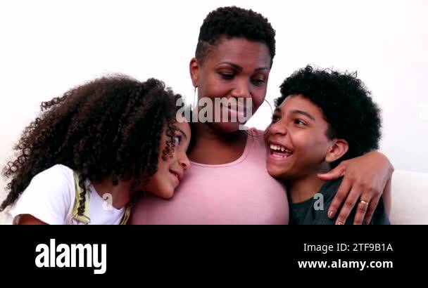 Loving mother and kids hug. Mom embracing children. African ethnicity ...