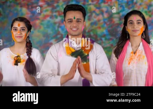 Three Indian youngsters greeting people with a Namaste gesture on the ...