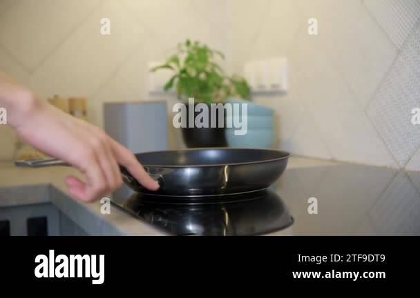 Modern kitchen appliance. Woman hand turn on induction stove to cook ...