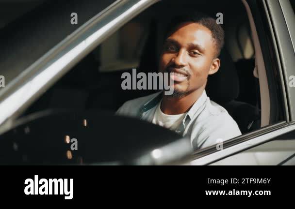 Happy auto owner buying transport at modern salon. Handsome man looks ...