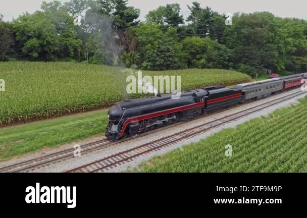 An Aerial Front to Side View of a Steam Passenger Train Blowing Smoke ...